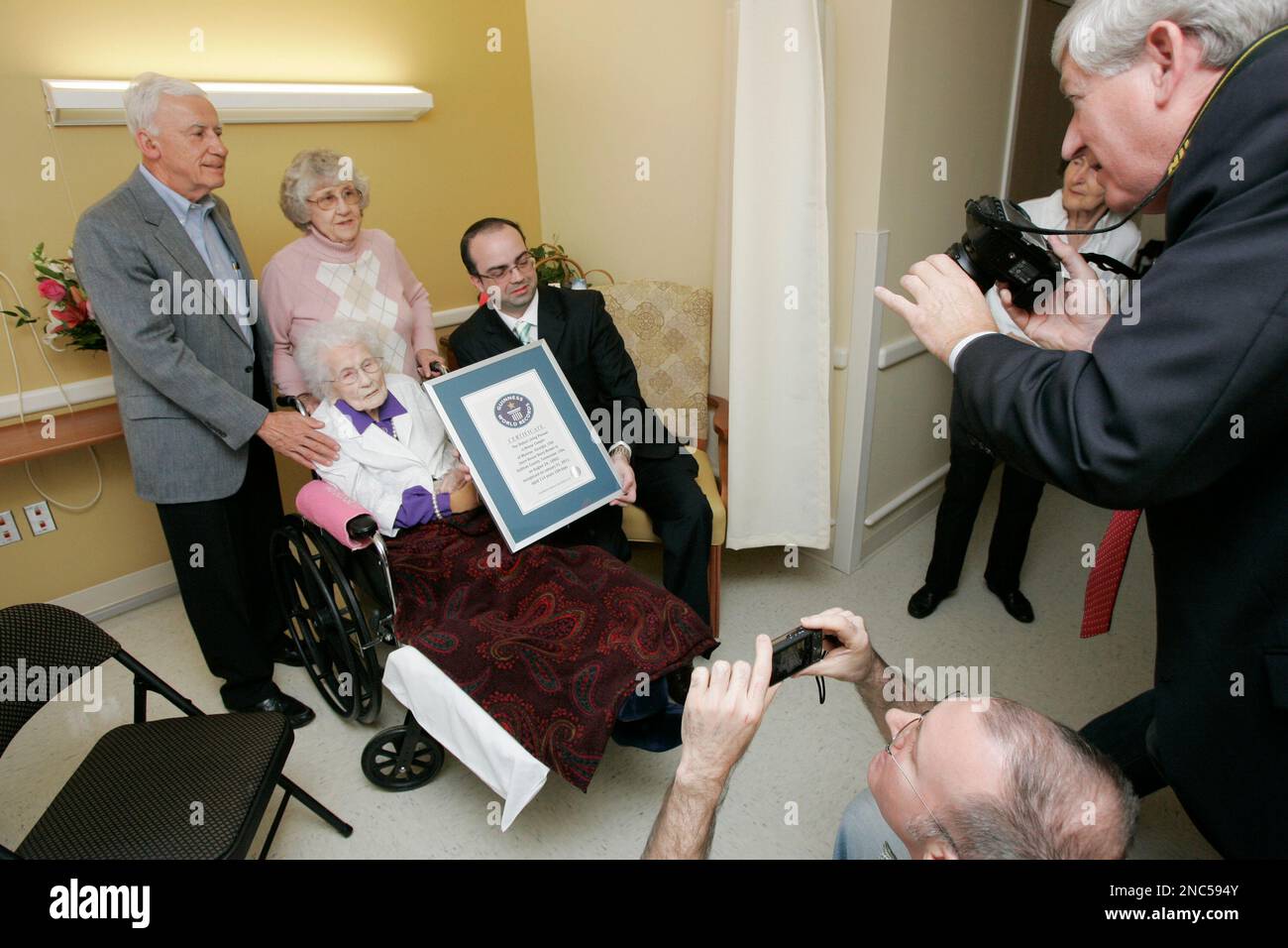 Besse Cooper, 114, in wheelchair, pose for media and family, with son ...