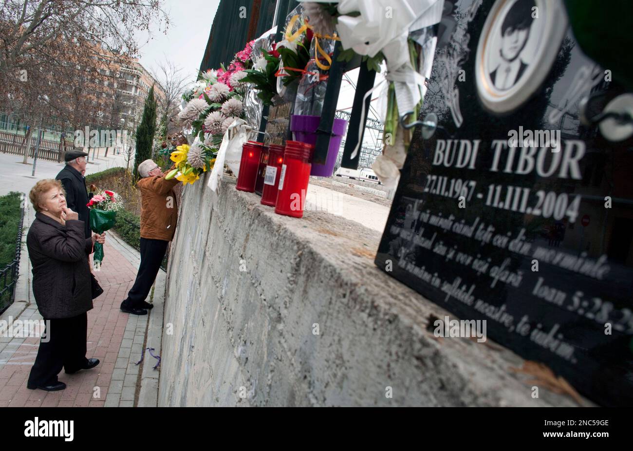 People place flowers in remembrance of the victims of the Madrid 2004 ...