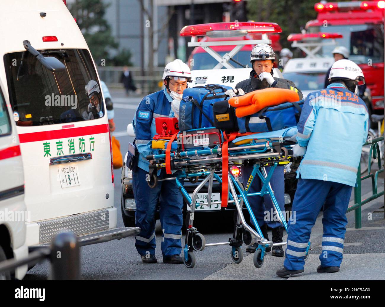 Tokyo Fire Department rescue workers arrive at Kudan Kaikan in Tokyo as ...