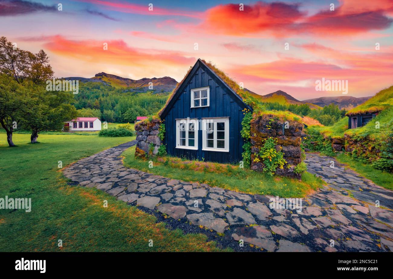 Typical view of Icelandic turf-top houses. Spectacular summer sunrise ...