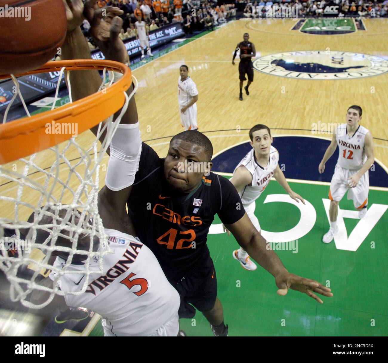 Miami's Reggie Johnson (42) dunks over Virginia's Assane Sene (5 ...