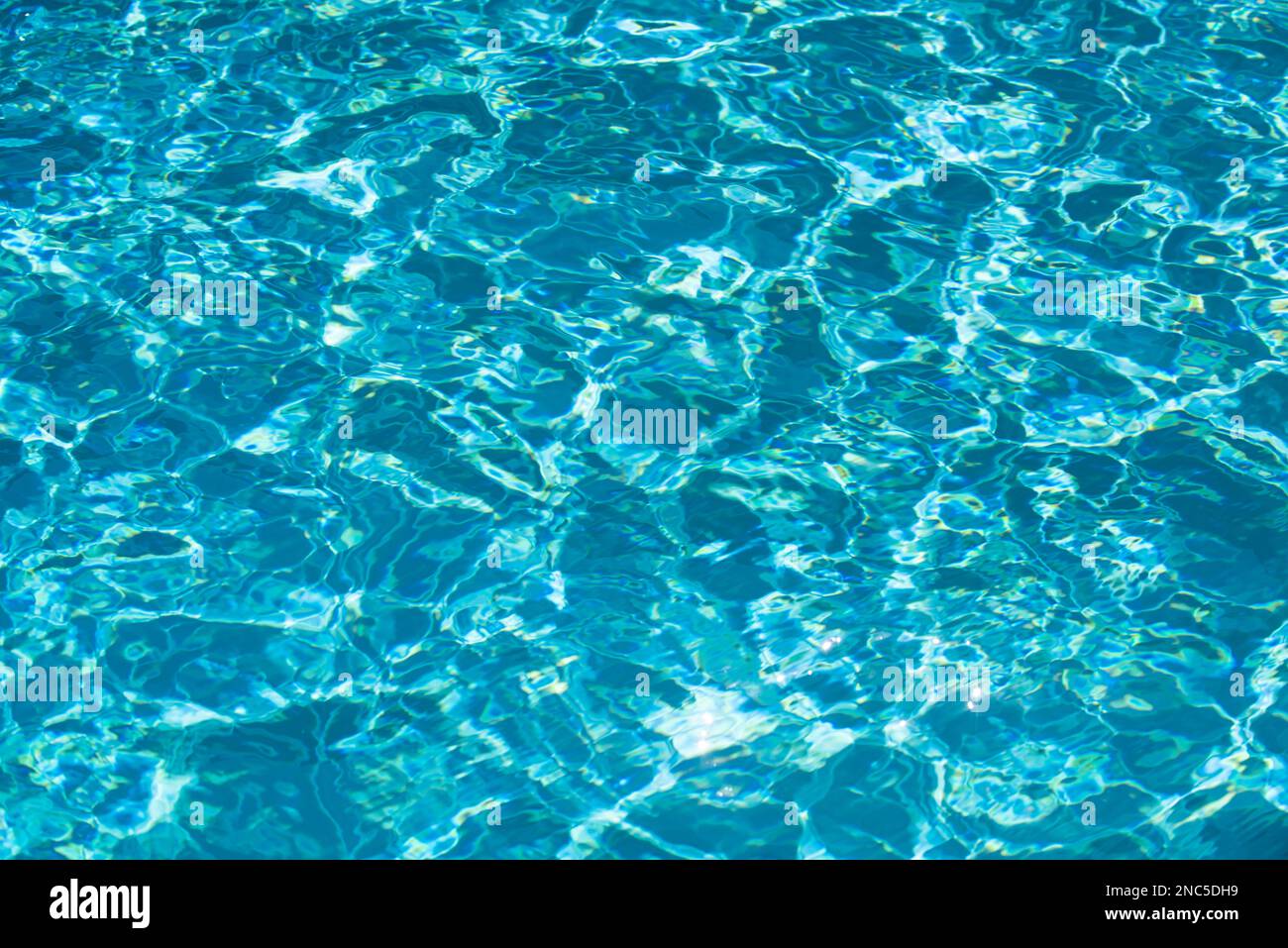Ripple Water in swimming pool with sun reflection. Wavy water ...