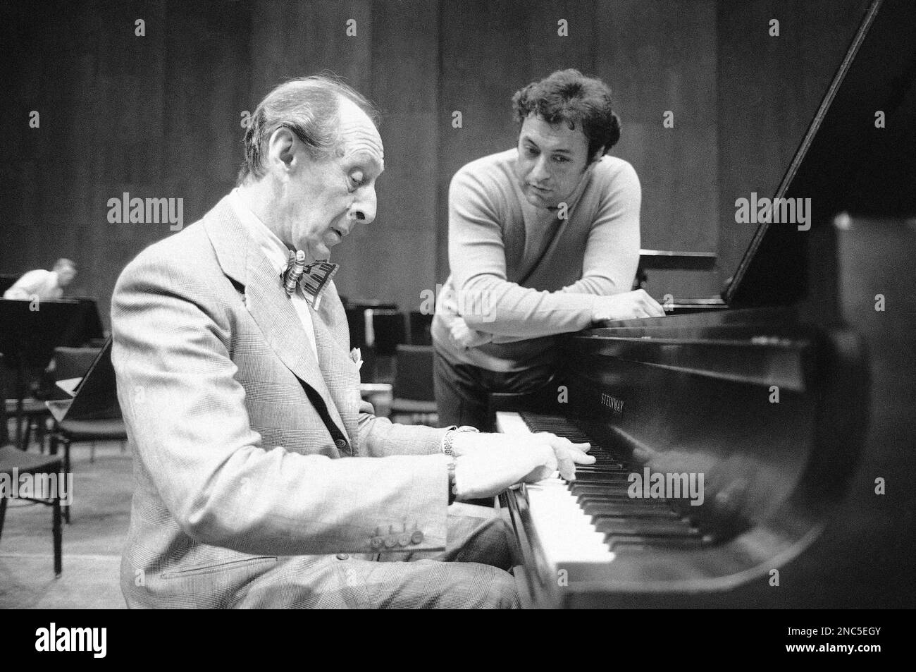 As pianist Vladimir Horowitz plays, Maestro Zubin Mehta looks on during ...
