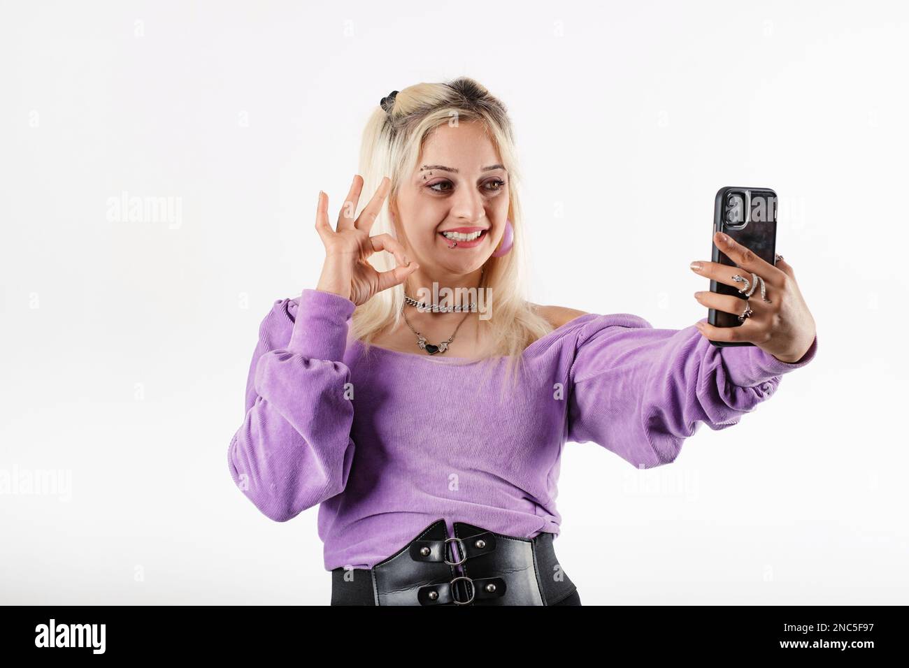 Happy woman wearing blouse standing isolated over white background ...