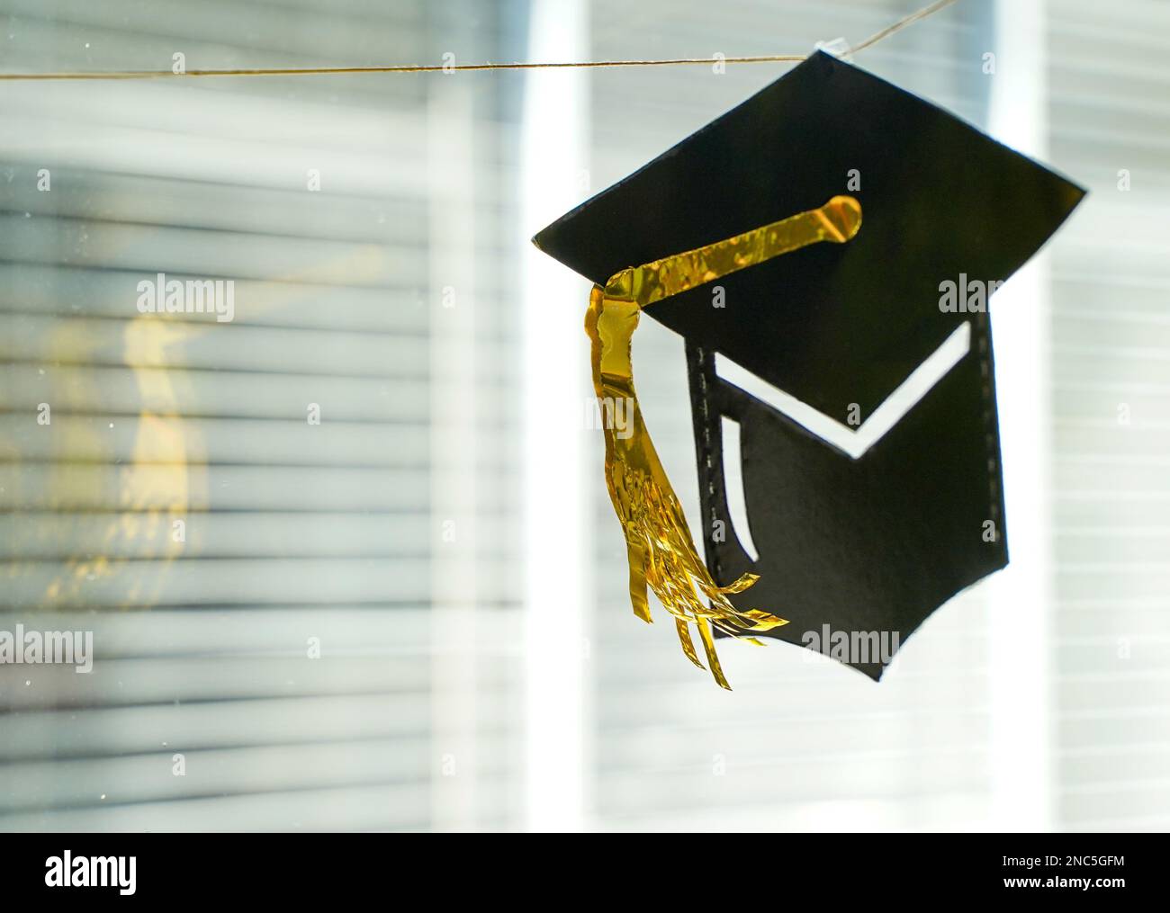 A closeup view of a black graduation cap with yellow brim Stock Photo ...