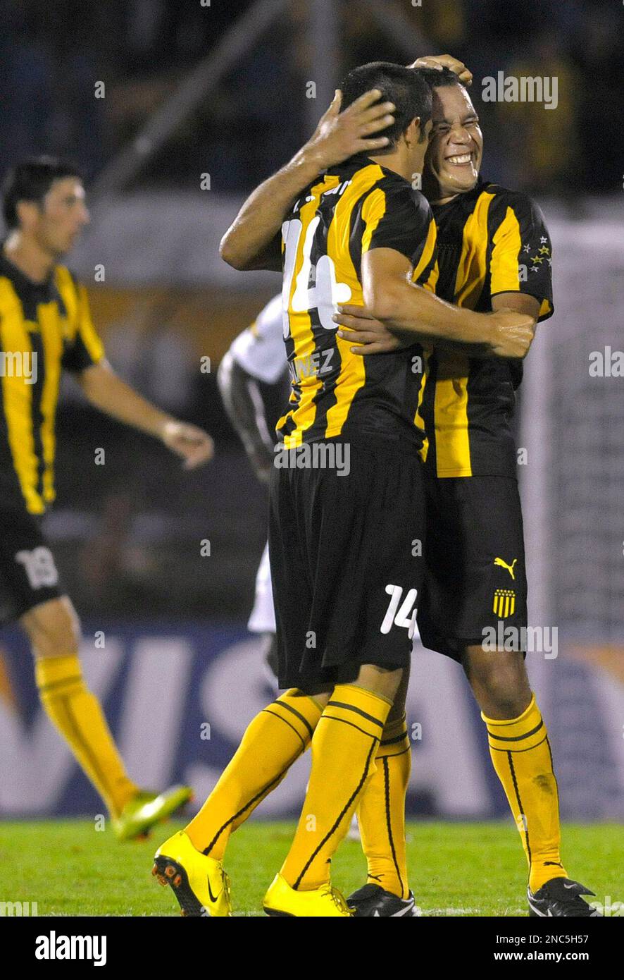 Luis Aguiar of Uruguay's Penarol, second from left, embraces teammate ...