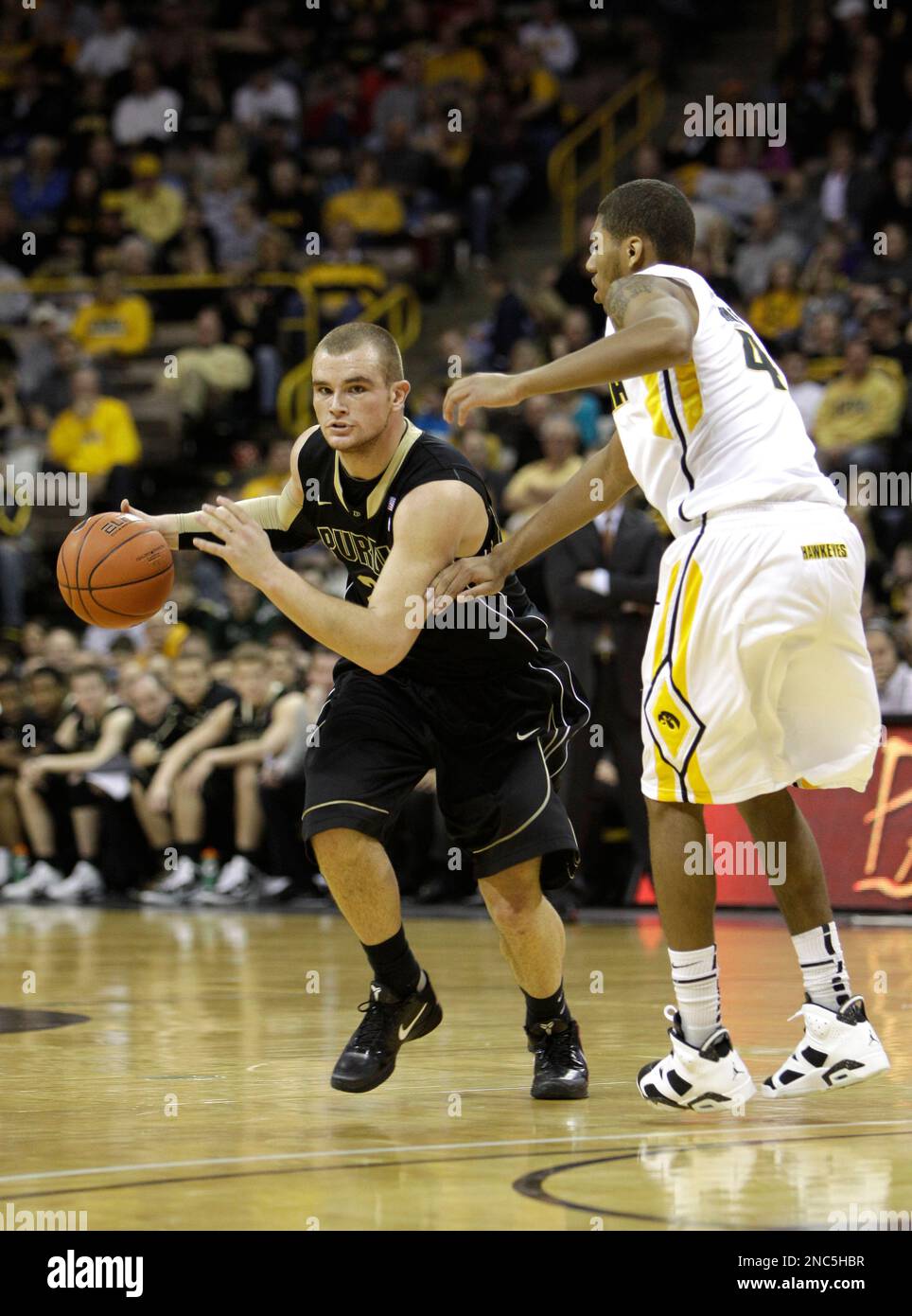 Purdue guard D.J. Byrd, left, drives past Iowa guard Roy Devyn Marble ...
