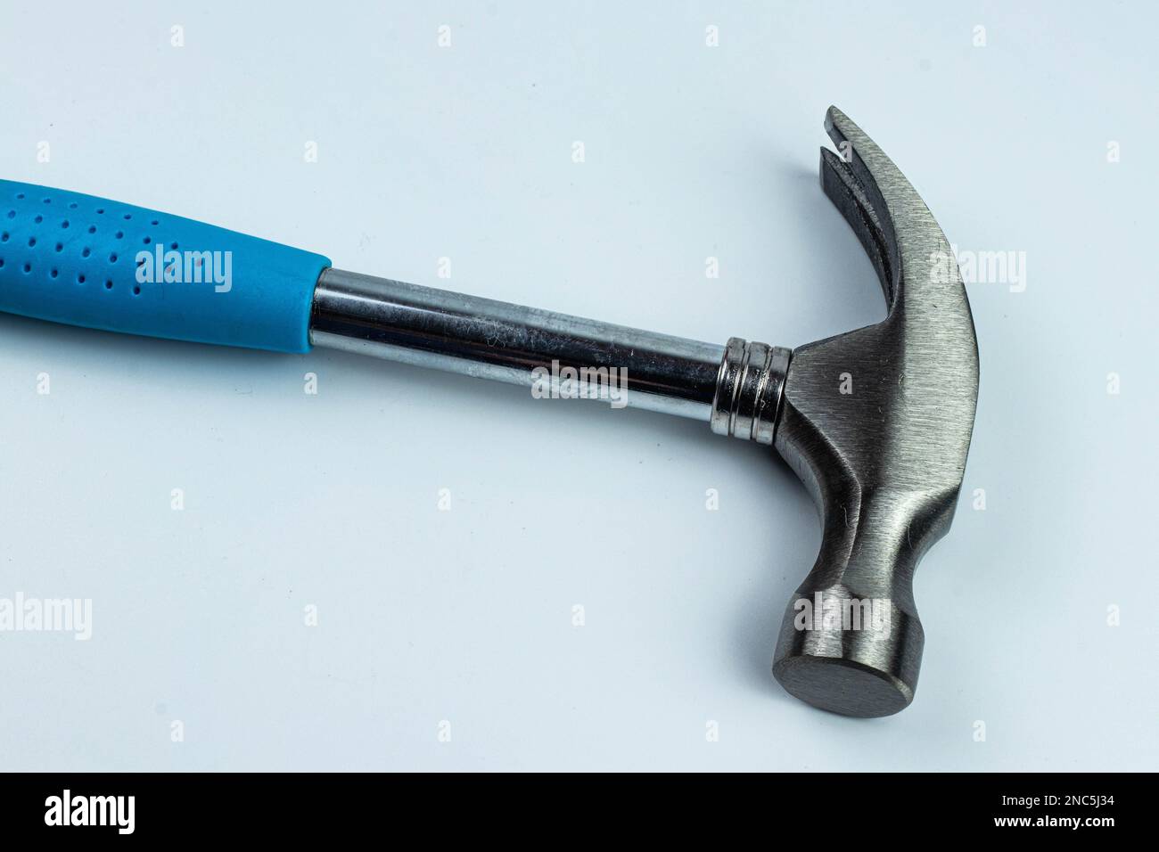 A closeup view of a blue tailed metal mallet isolated on a white ...
