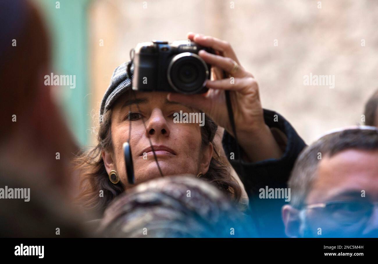 Israeli right wing activist Nadia Matar takes a photograph as she and a ...