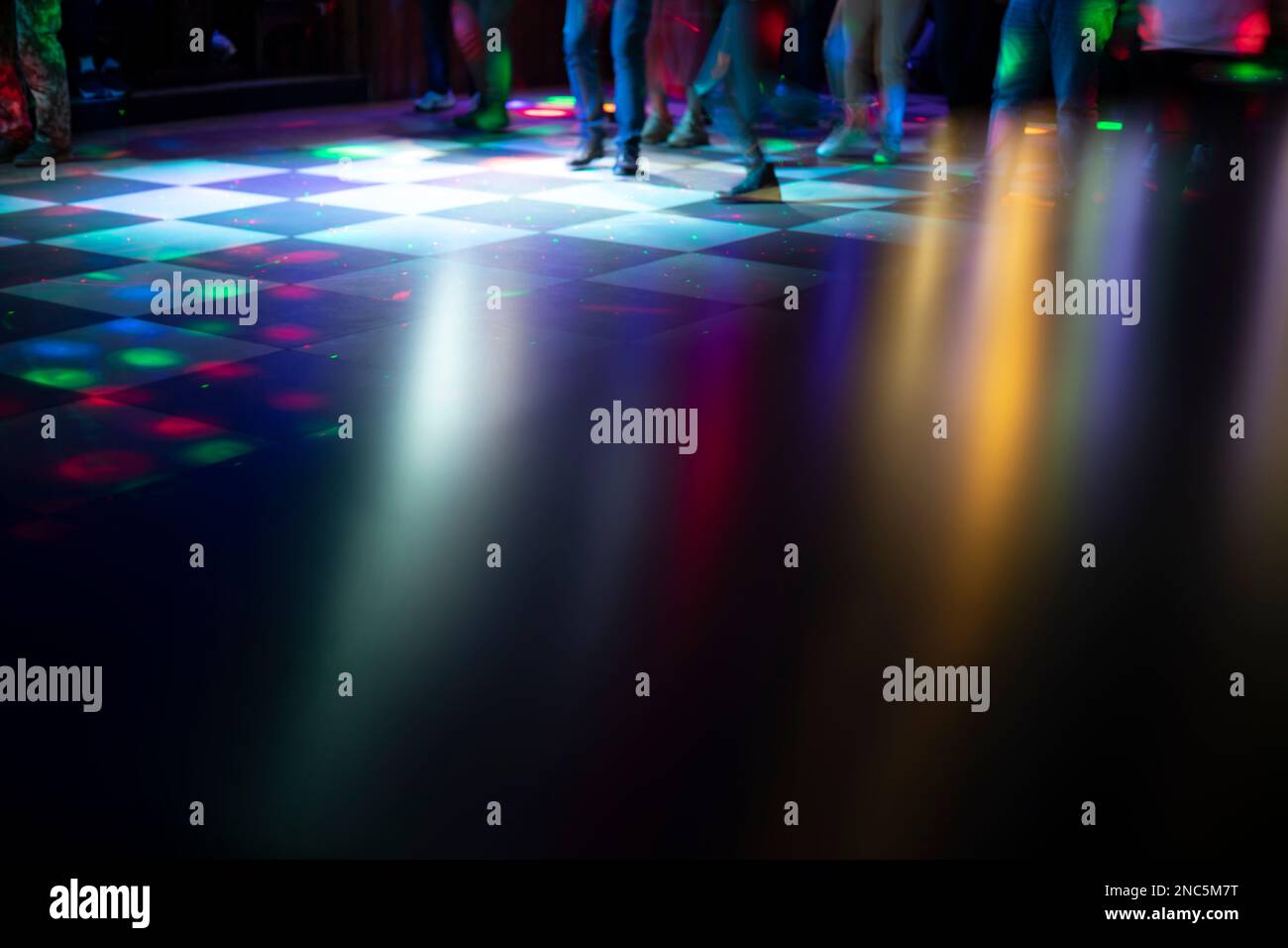 Disco in bar. Color music on dance floor. Bright colors in night club ...