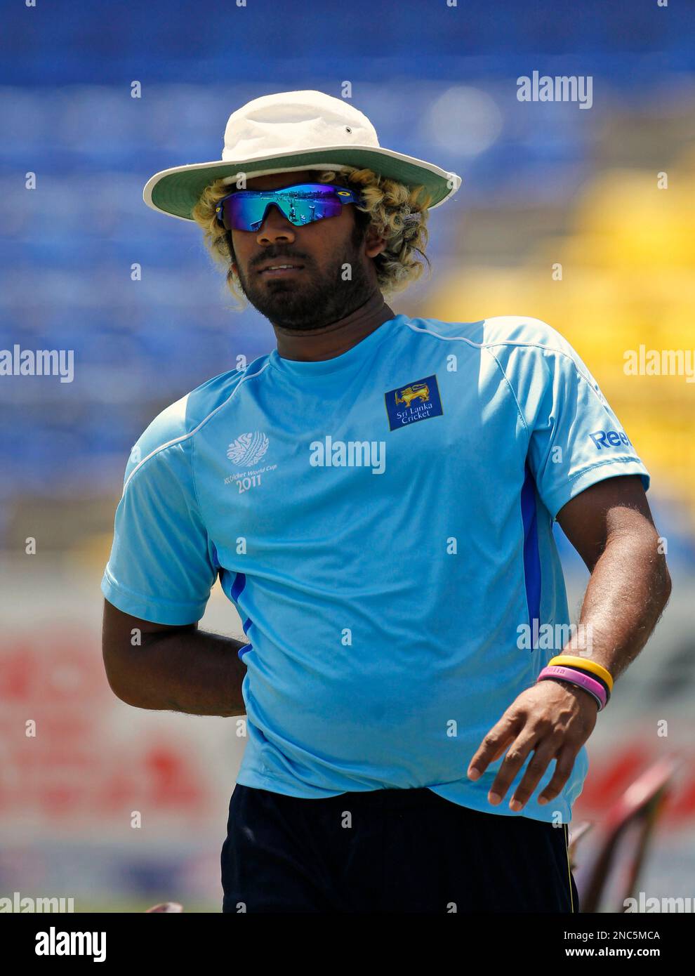 Sri Lankan bowler Lasith Malinga stretches his back during a practice ...
