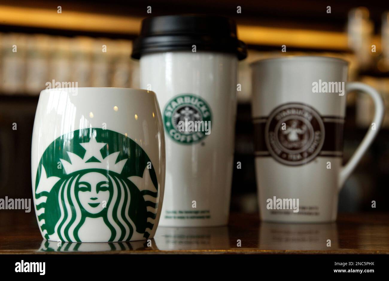 The new Starbucks Corp. logo is shown next to older versions of the ...