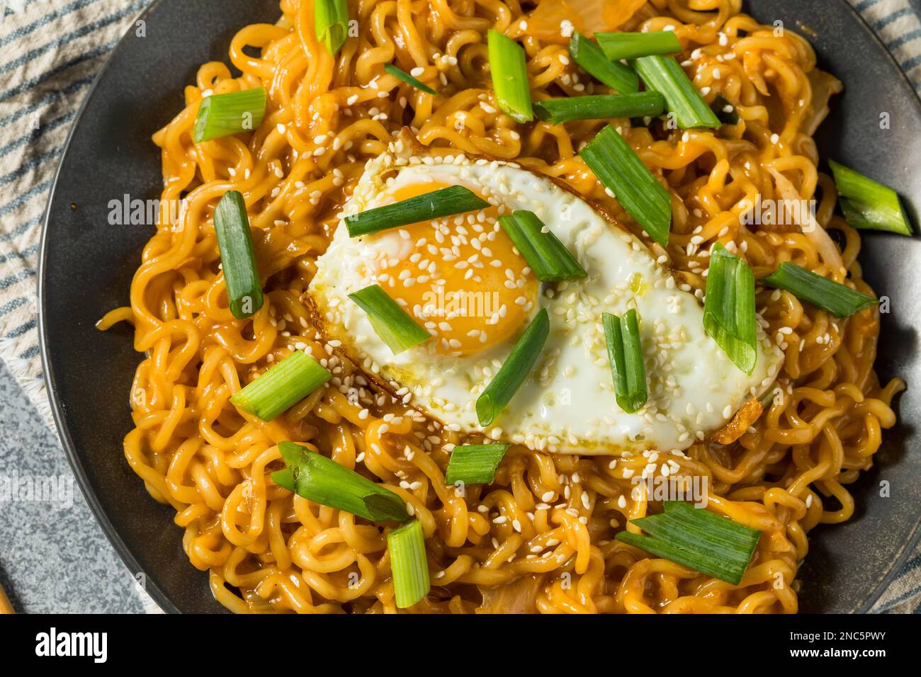 Korean Cheesy Kimchi Noodles with Soy Sauce and an Egg Stock Photo - Alamy