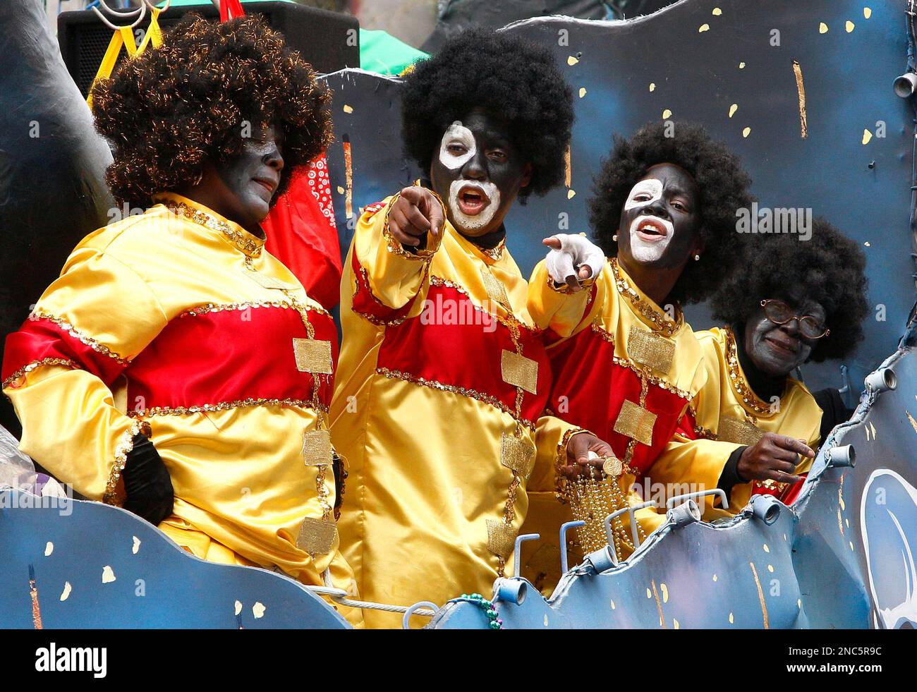 Members of the Zulu Social Aid and Pleasure Club point to revelers as ...