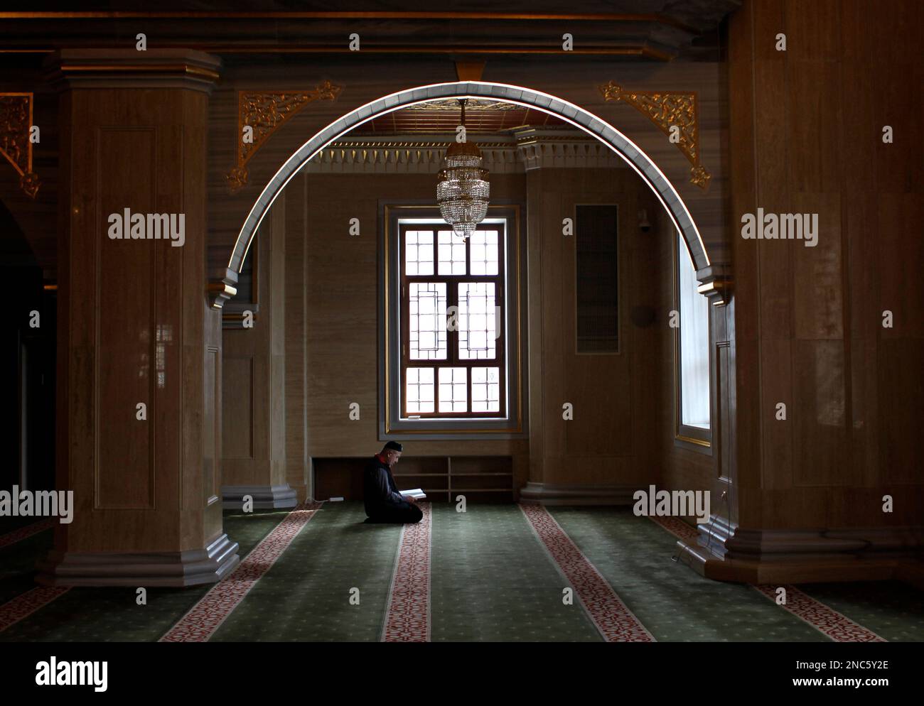 A Chechen man prays in the main mosque in Grozny, Chechnya, Monday ...