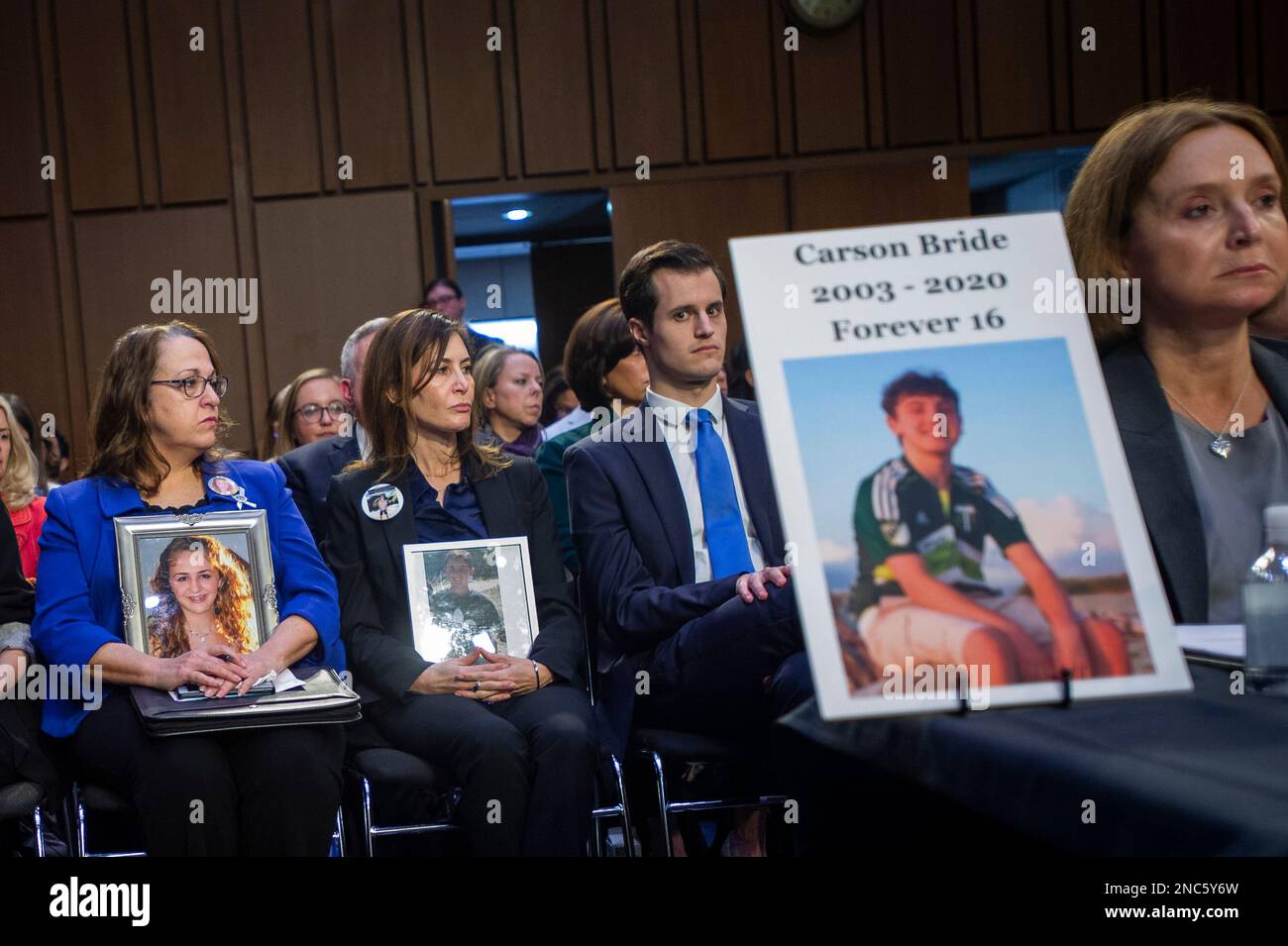Christine McComas, left, holds a photo of her daughter Grace McComas ...