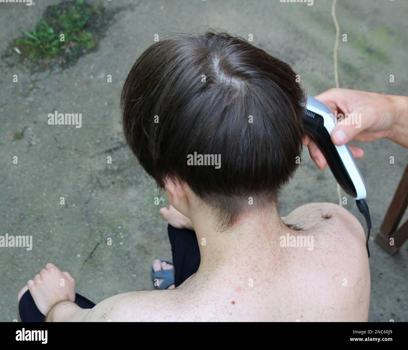 change of image of a young man with cutting long hair, a man cuts a ...