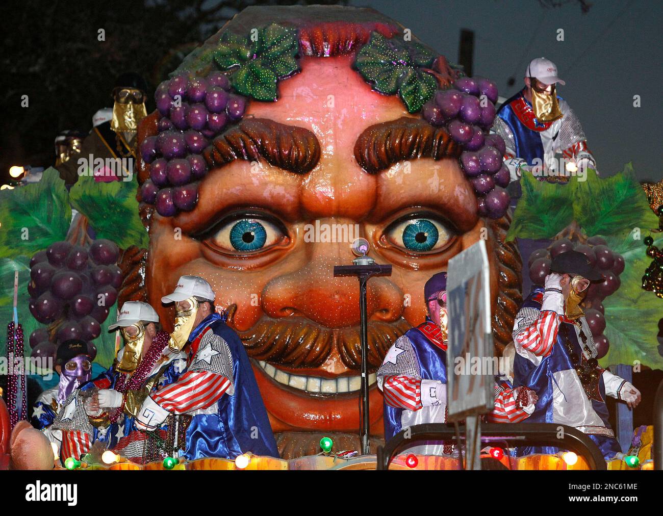 A float carrying members of the Krewe of Bacchus Mardi Gras parade ...