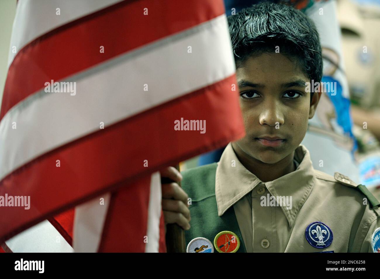 Boy Scout Omar Farooq, 12, presents the U.S. flag for the pledge of ...