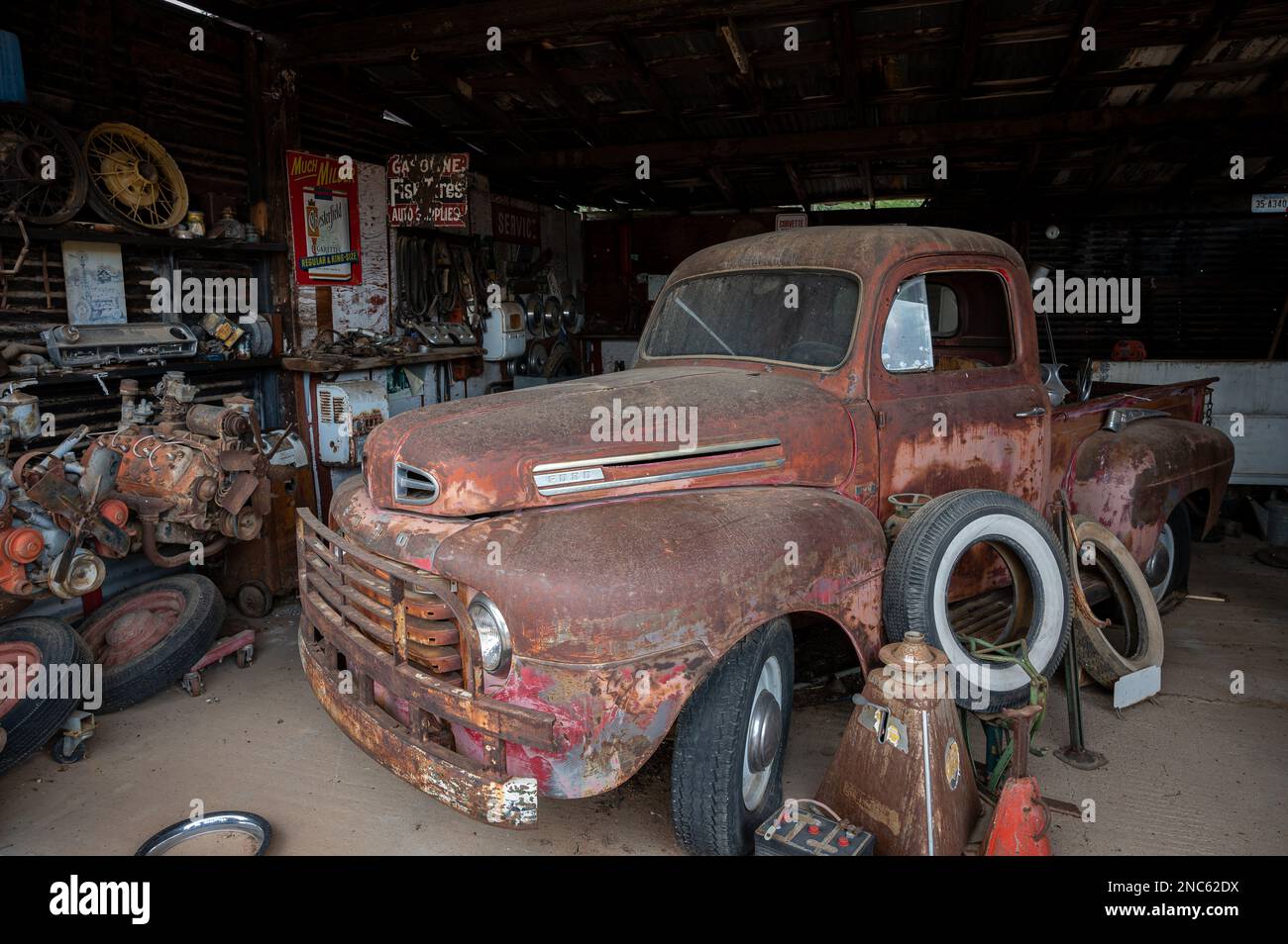 An old abandoned car mechanic shop on the desert road in old Ford F-1 ...