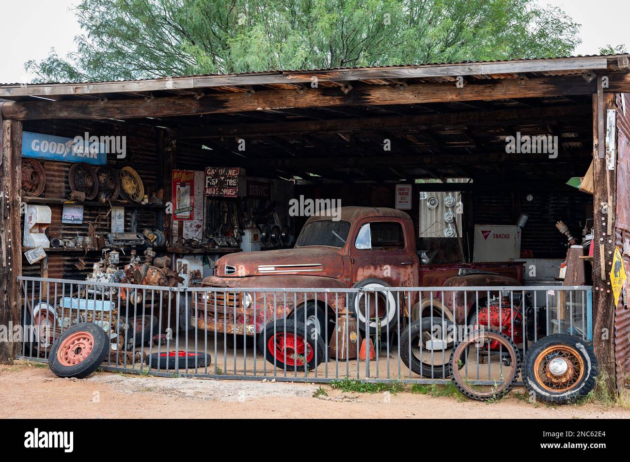 An Old abandoned car mechanic shop on the desert road. Inside is an old ...