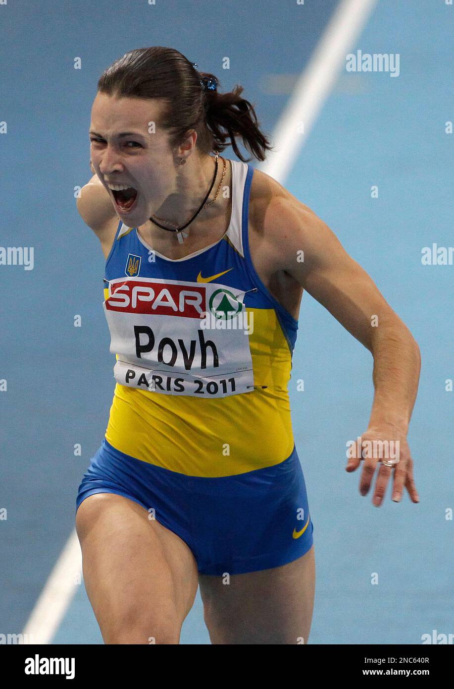 Olesya Povh of Ukraine celebrates as she crosses the finish line to win ...