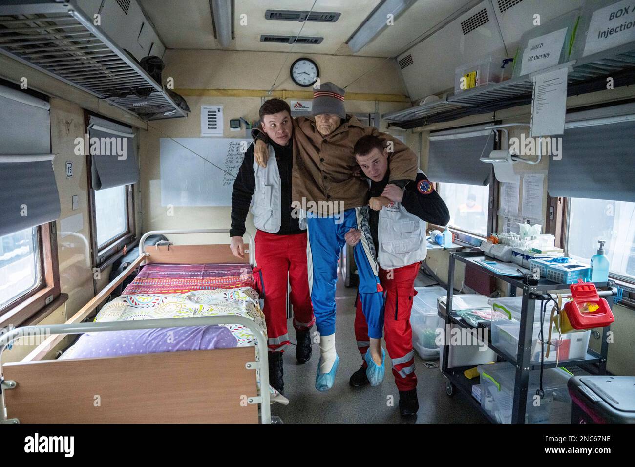MSF workers carry a man inside the MSF medical train that evacuates ...