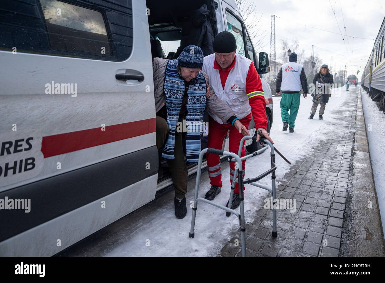MSF worker helps a woman to get inside the MSF medical train that ...
