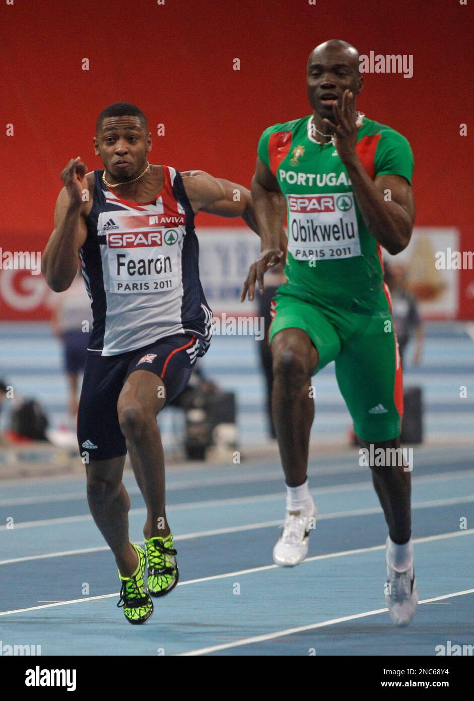 Portugal's Francis Obikwelu, right, runs with Britain's Joel Fearon ...