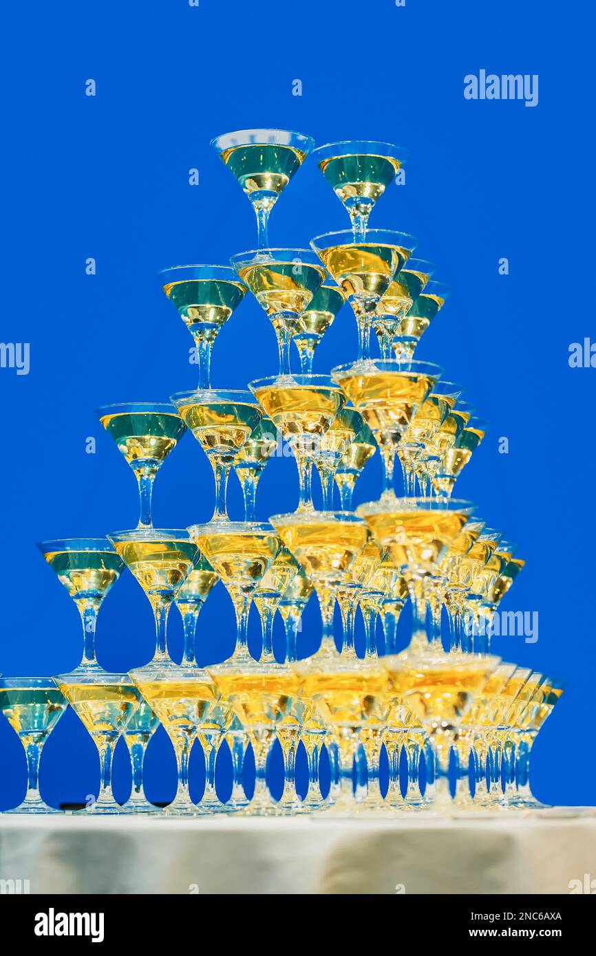 Champagne glasses standing in tower, festive party. Pyramid of glasses ...