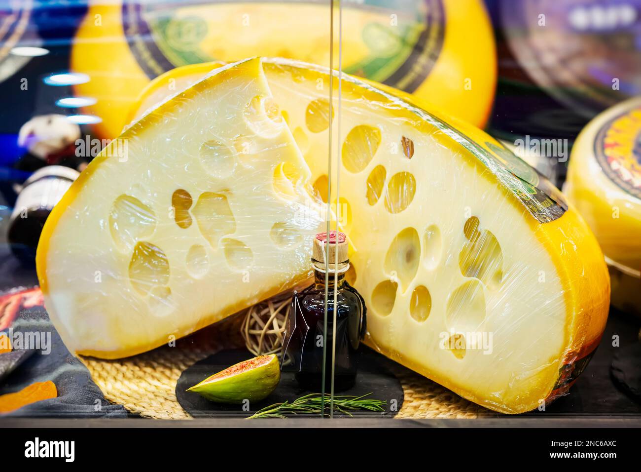Big cut head of cheese closeup on showcase on counter at store, real ...
