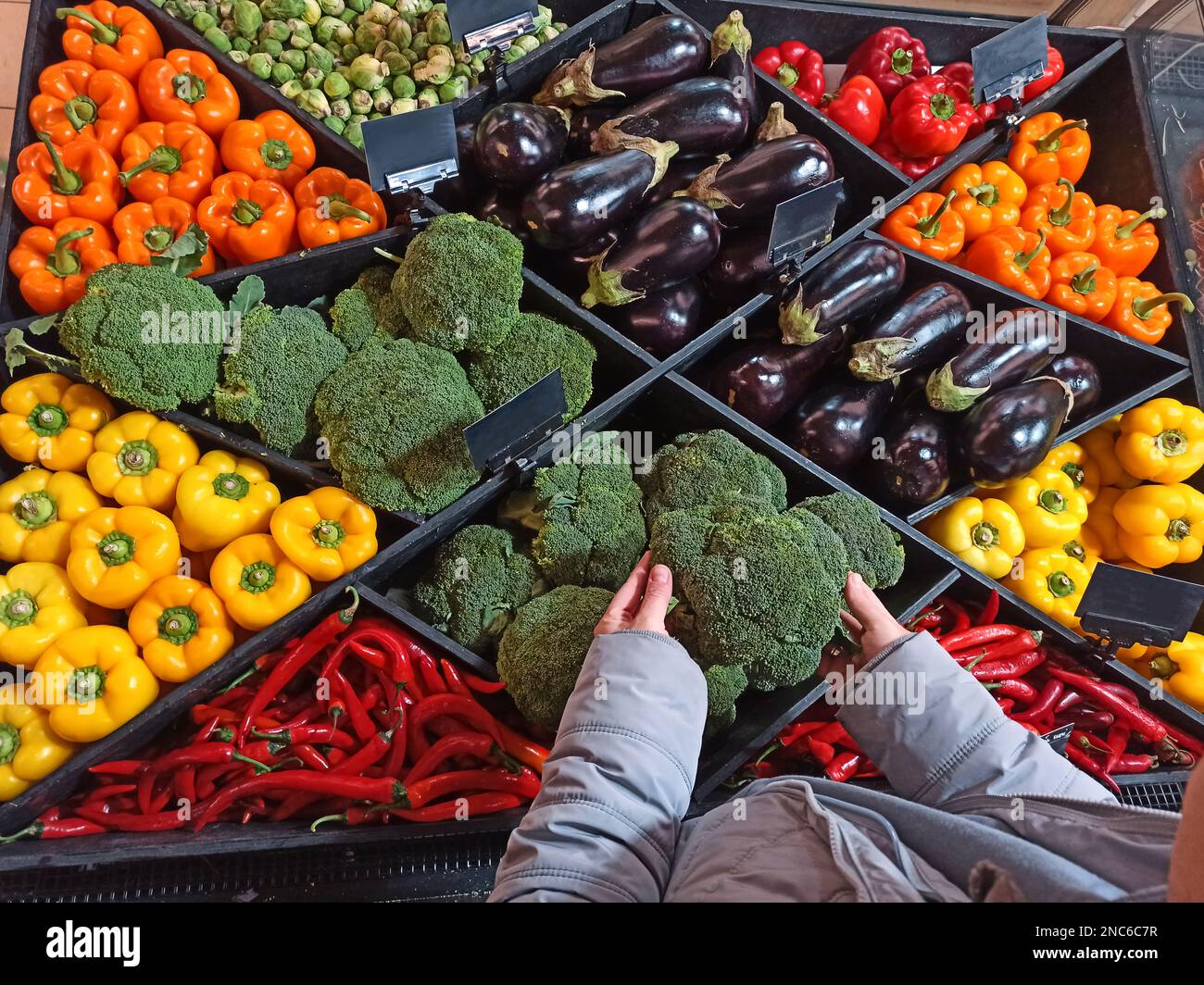 Top view customer chooses broccoli while shops for groceries in ...