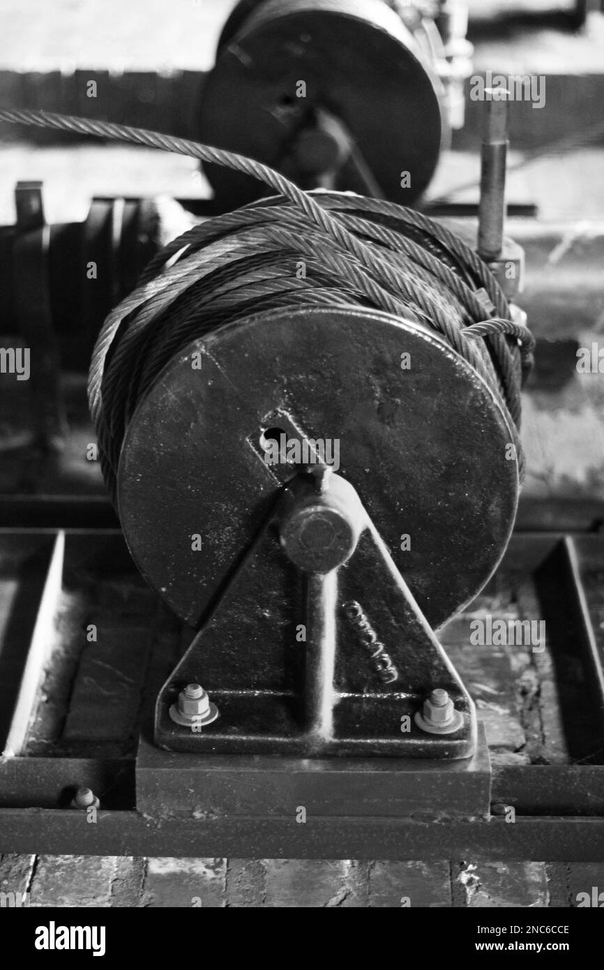 Common steel cable wound round a hand crank mechanical winding machine ...