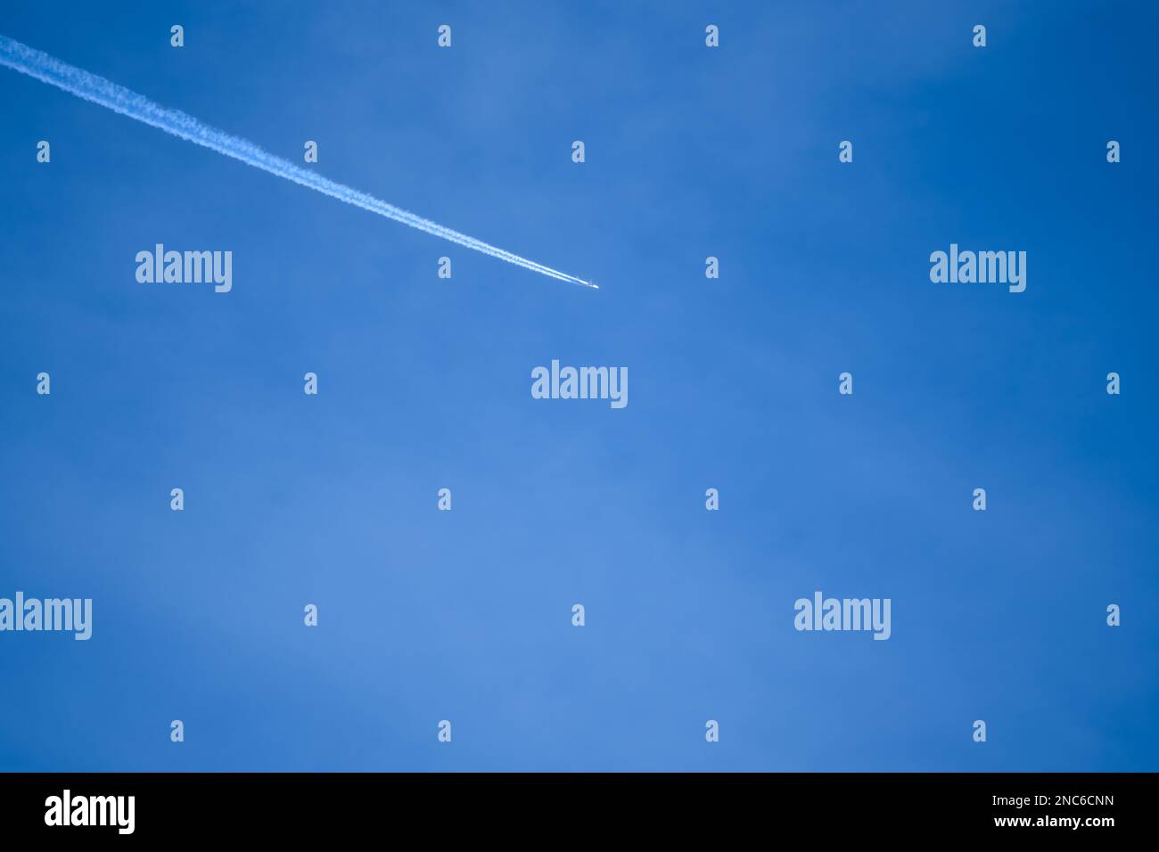 high altitude twin engine contrails (jet airplane vapour trails) across ...