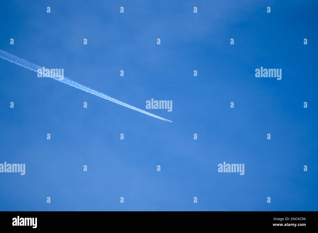 high altitude twin engine contrails (jet airplane vapour trails) across ...