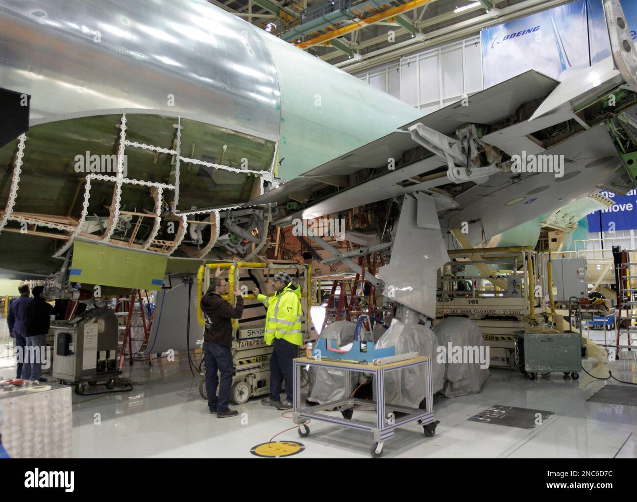 Boeing Co. workers stand next to a Boeing 767 being assembled in ...