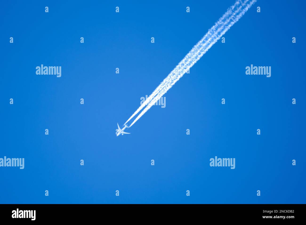 high altitude twin engine contrails (jet airplane vapour trails) across ...