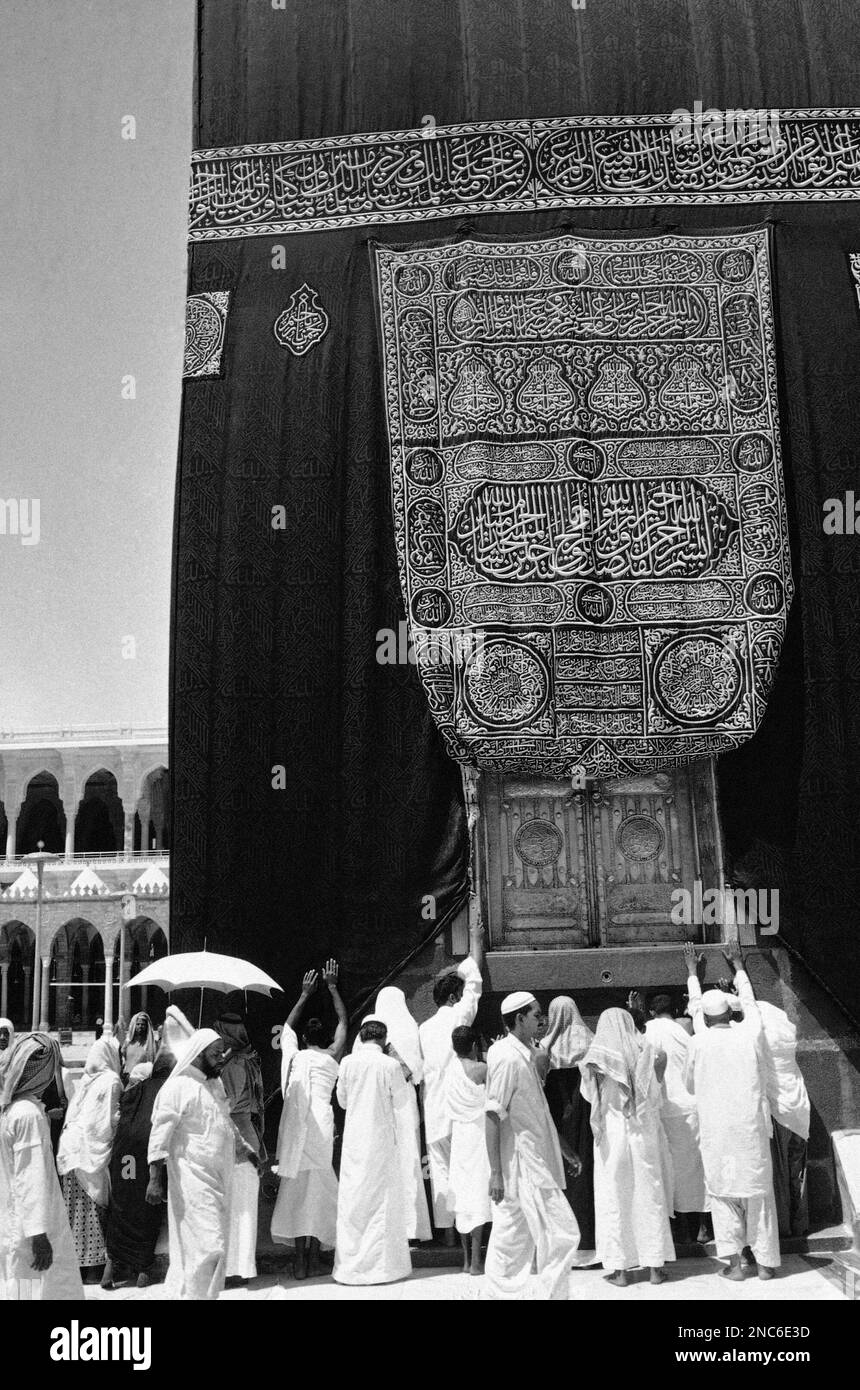 Veiled women and men attired in the garment known as Ihram, circle ...