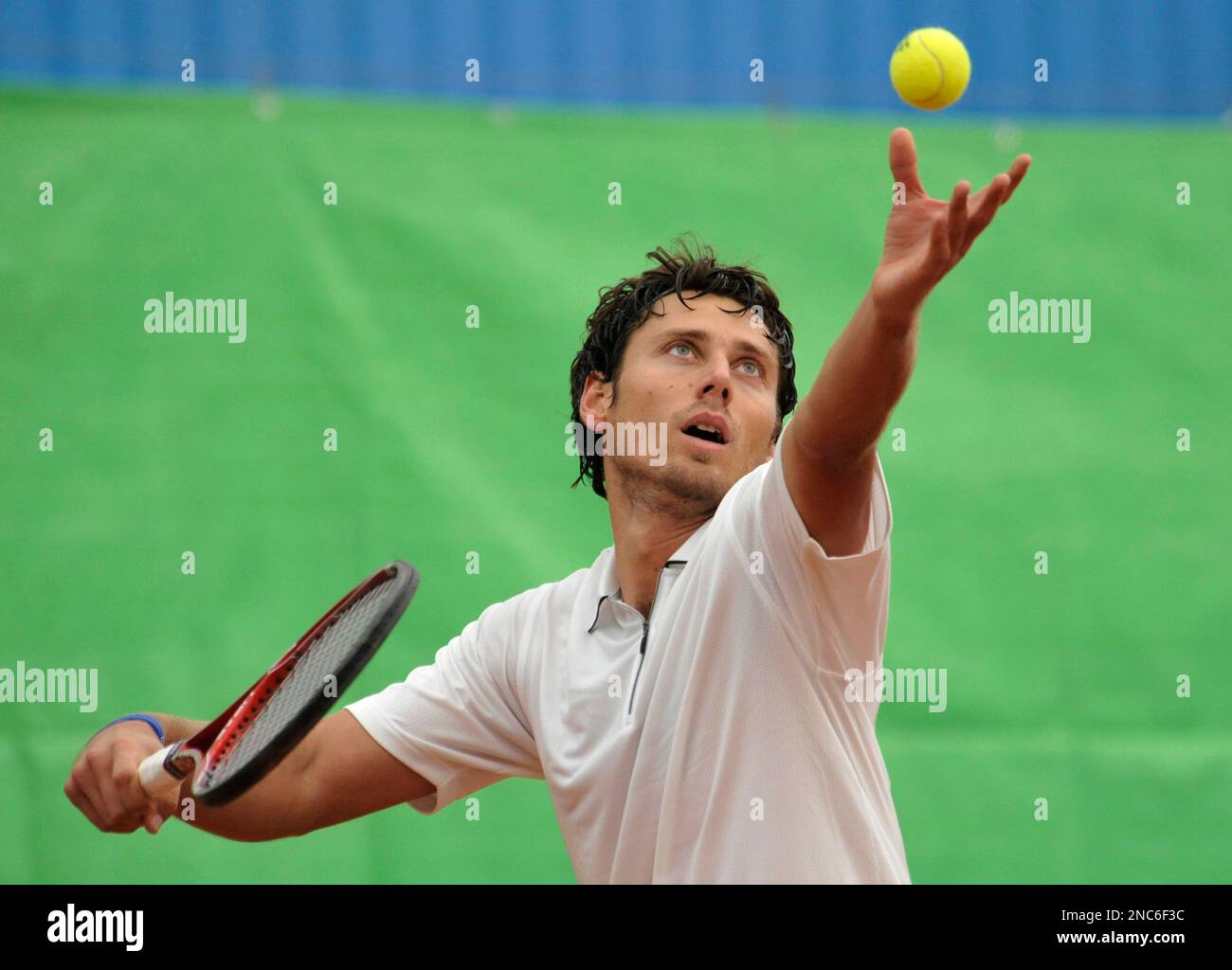 Artem Sitak of New Zealand returns a shot to Farrukh Dustov of ...