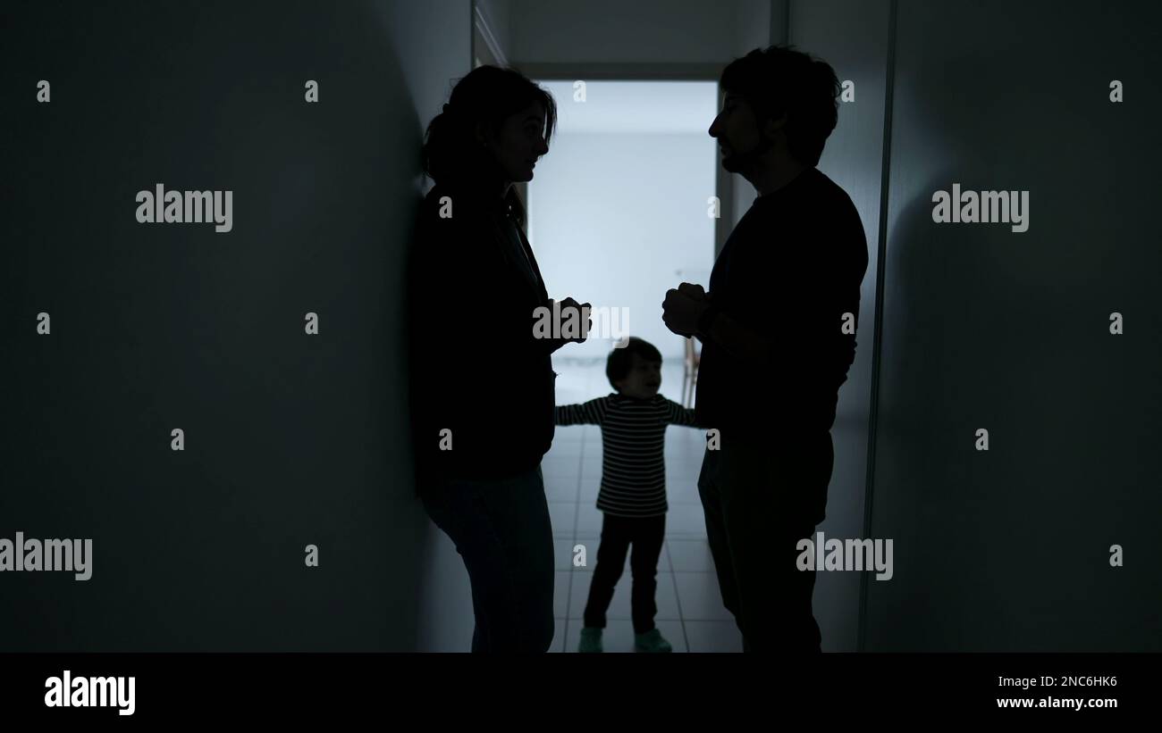 Couple discussing relationship with child in the middle. Silhouettes of ...
