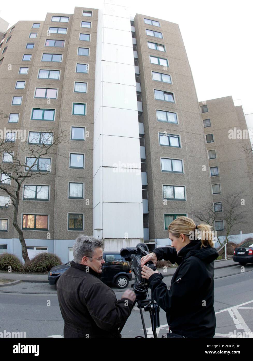A TV team stand in front of the house where the alleged gunman lived in ...