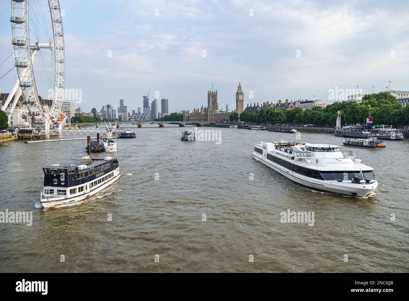 Cruise boats on the River Thames near the London Eye, London England ...
