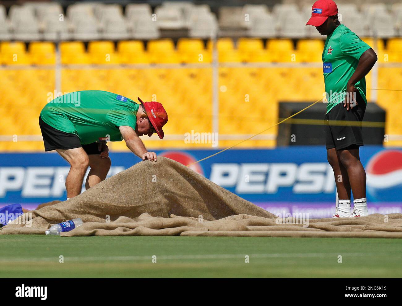 Zimbabwe's coach Alan Butcher, left, and Prosper Utseya inspect the ...
