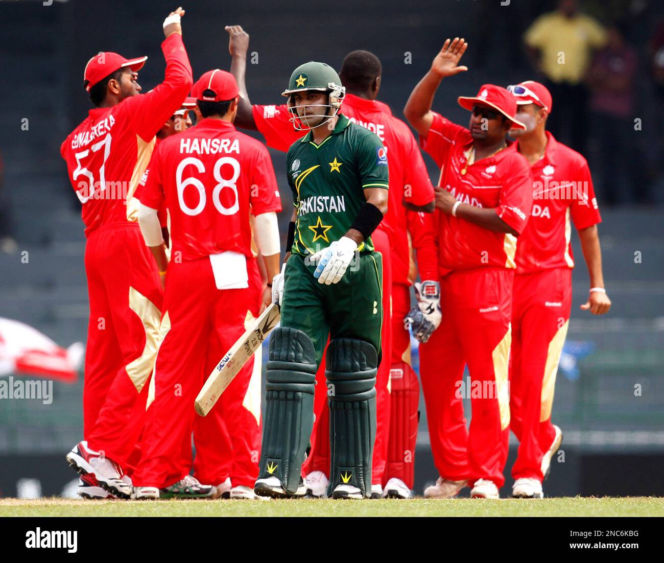 Pakistani batsman Mohammad Hafeez, front, walks away after being ...