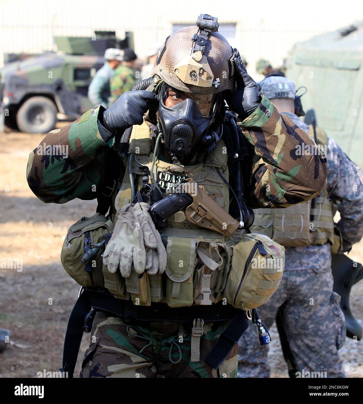 U.S. soldier from the 2nd Infantry Division wearing gas mask and anti ...