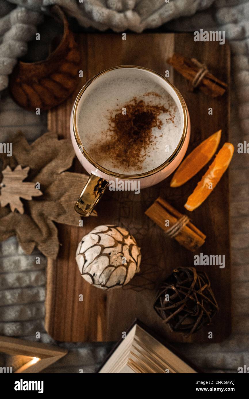 A vertical top view of the hot chocolate with chocolate powder, orange ...