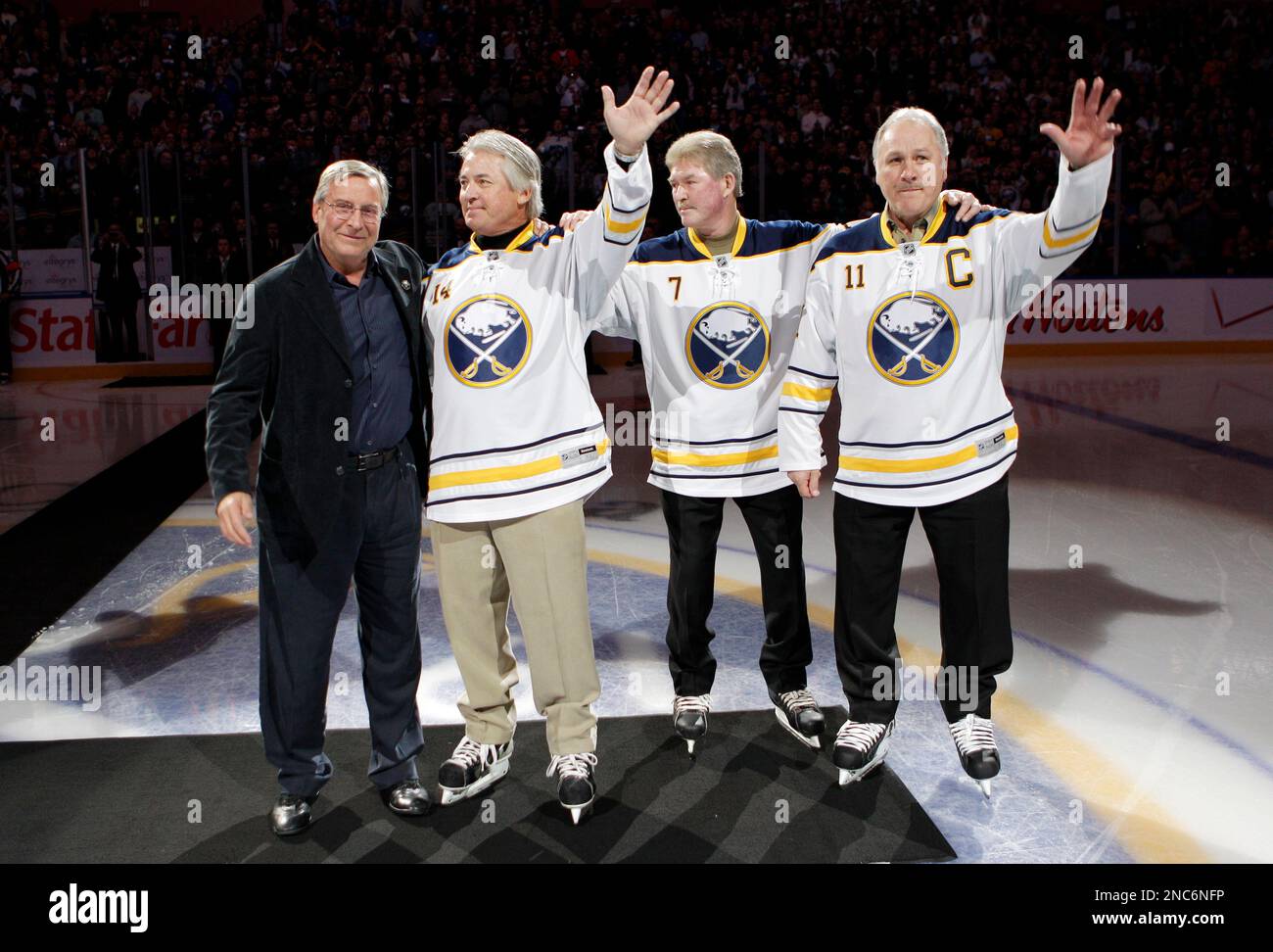Buffalo Sabres new owner Terry Pegula, left, greets the fans with ...
