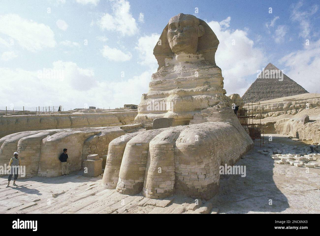 Workmen on scaffolding restore and add new stones to the giant Sphinx ...