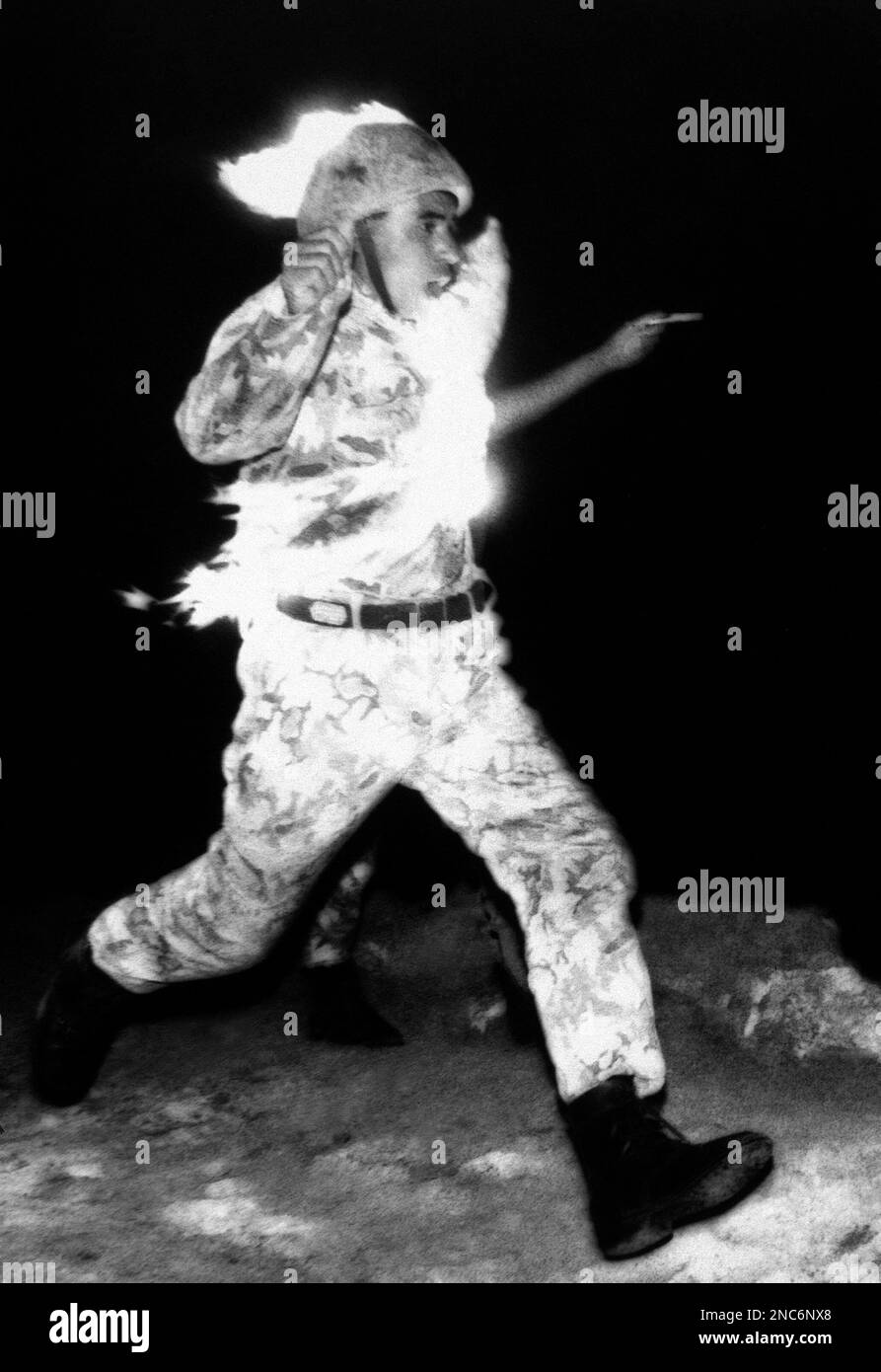 A soldier runs through Egypt’s desert after he was hit with napalm by ...