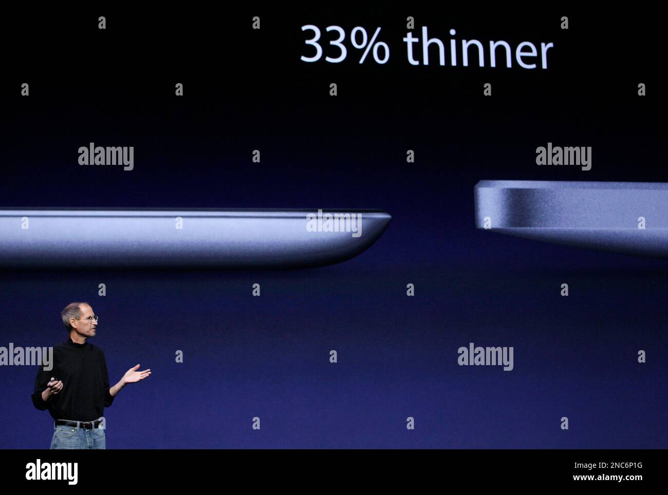 Apple Inc. Chairman and CEO Steve Jobs stands under images of the iPad ...